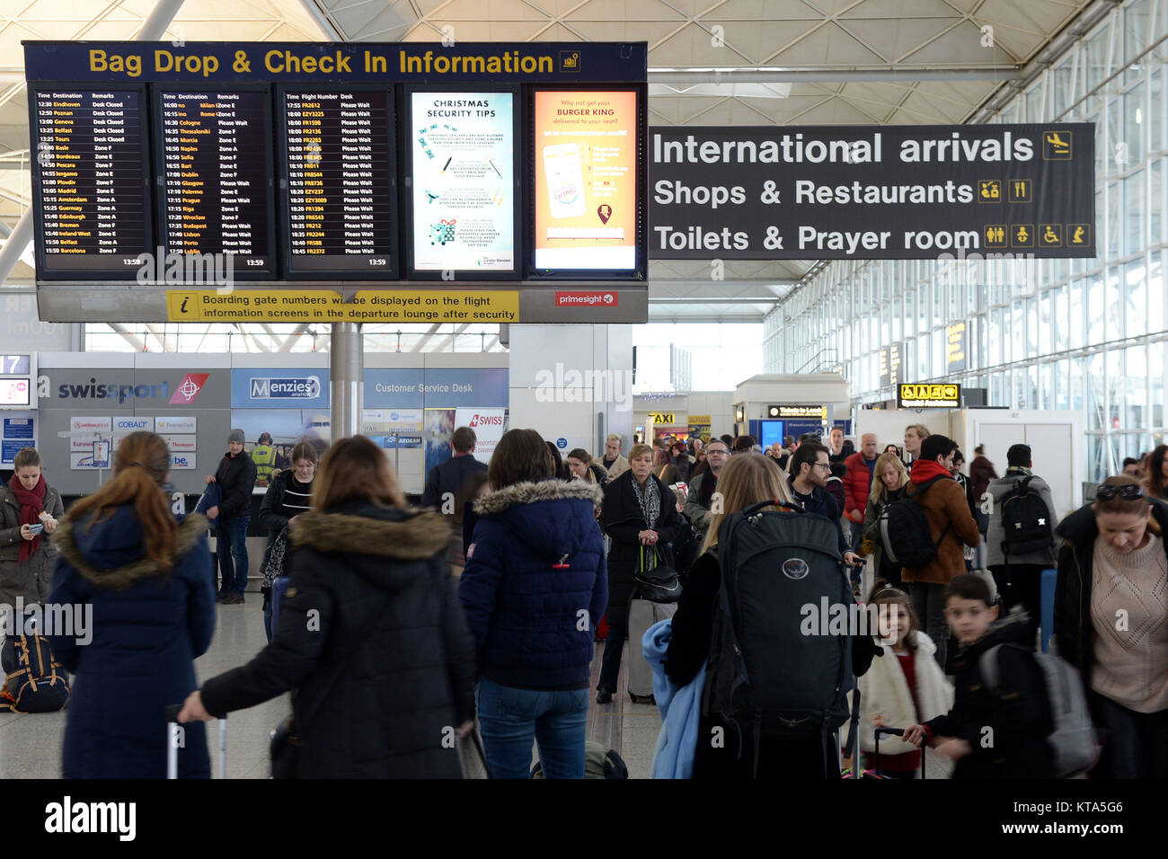 People view the check in information board at London Stansted Airport ...