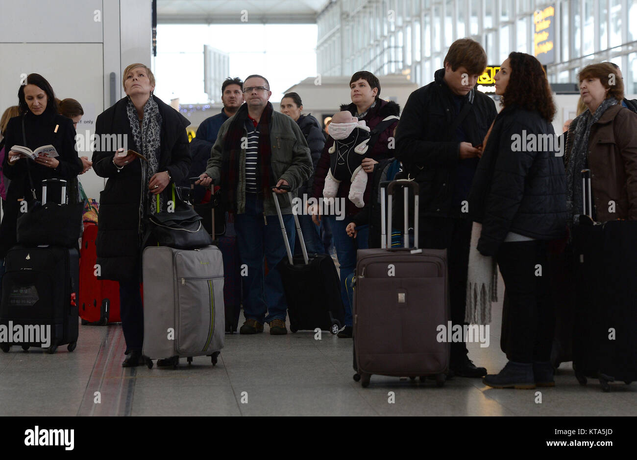 People view the check in information board at London Stansted Airport ...