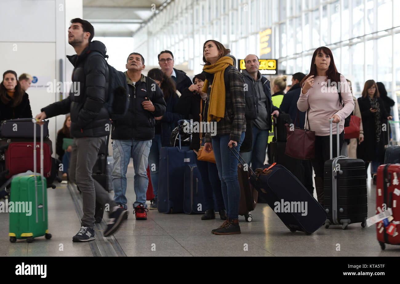 People view the check in information board at London Stansted Airport ...