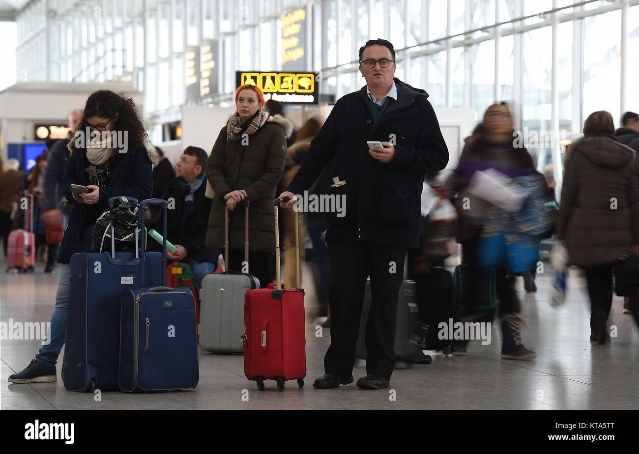 People view the check in information board at London Stansted Airport ...