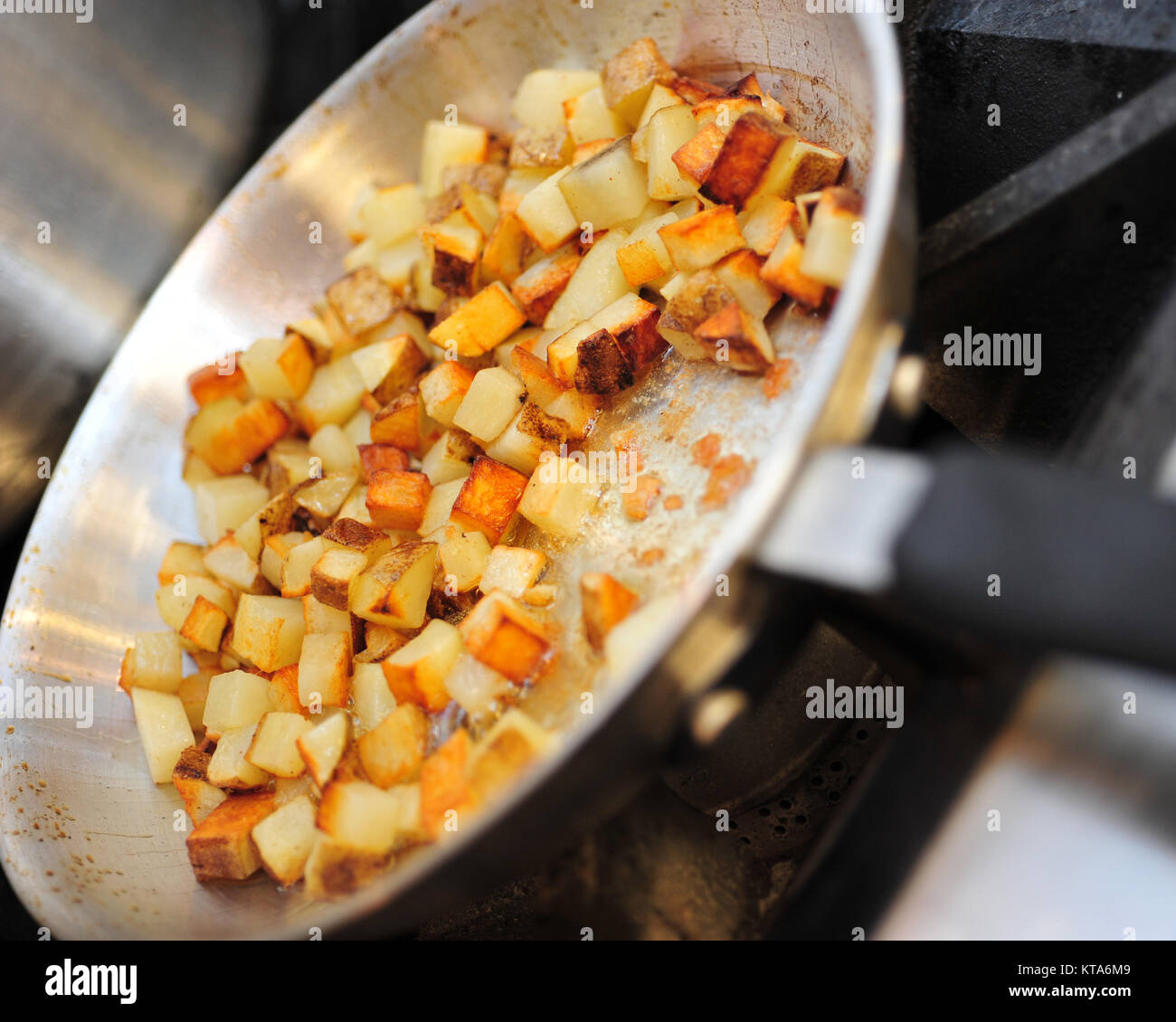 Potato cubes in a frying pan Stock Photo - Alamy