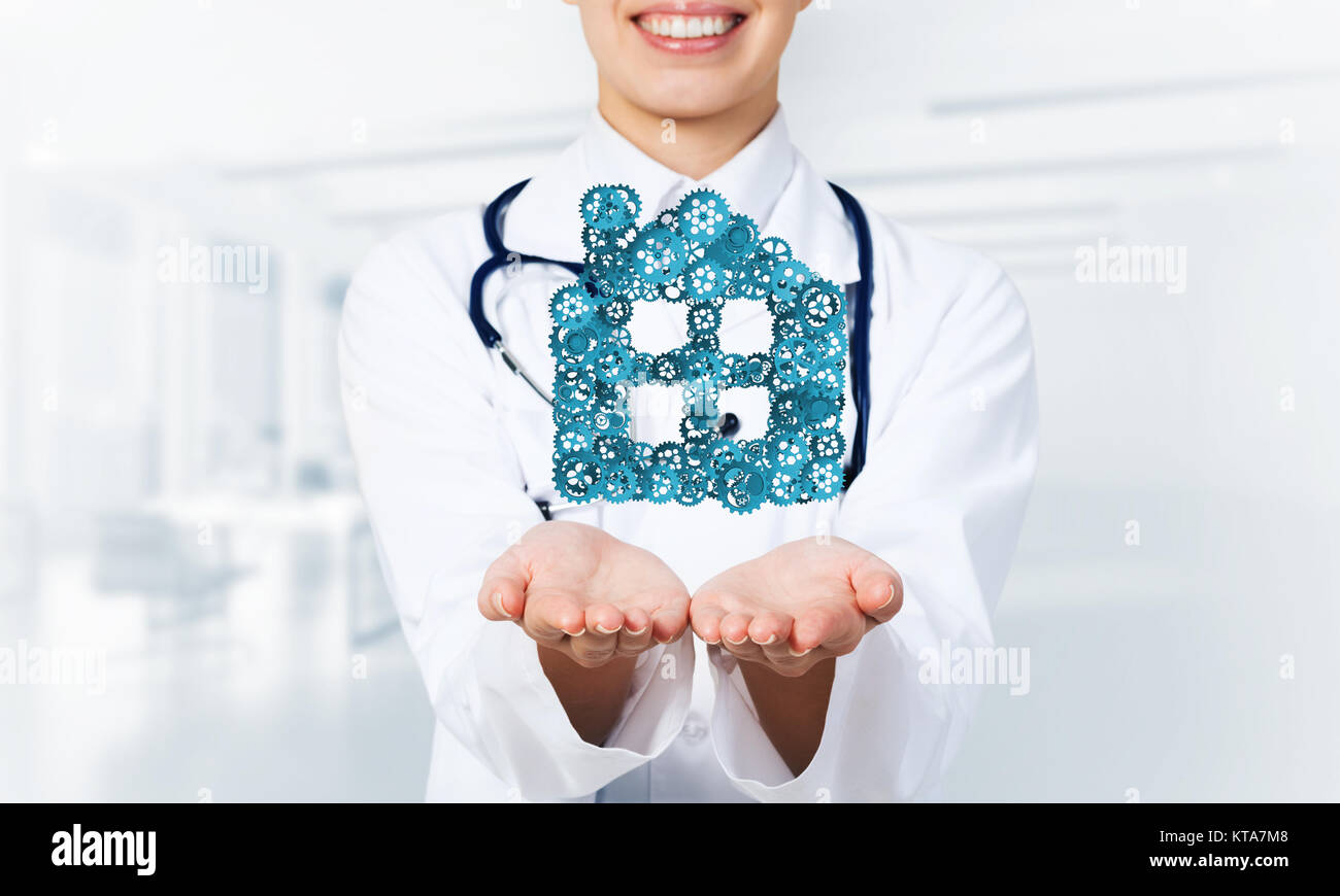 Hand of woman doctor showing house or home gear sign in palm Stock ...