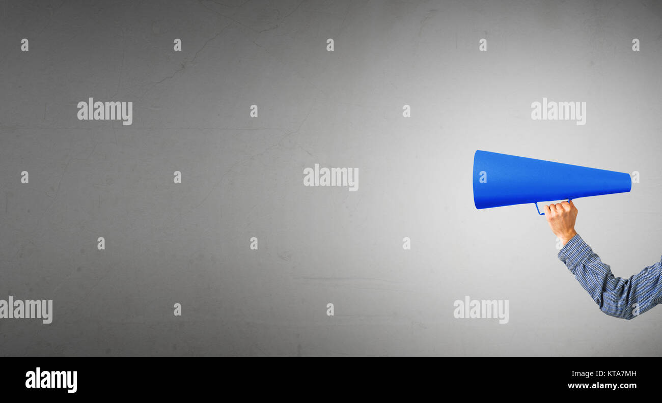 Close of man making announcement in paper trumpet Stock Photo - Alamy