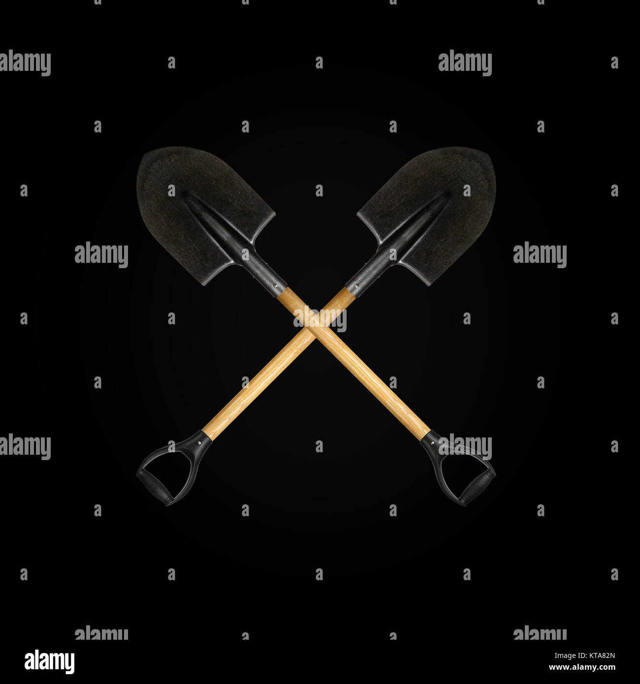 Two crossed shovels with a handle on a black background Stock Photo - Alamy