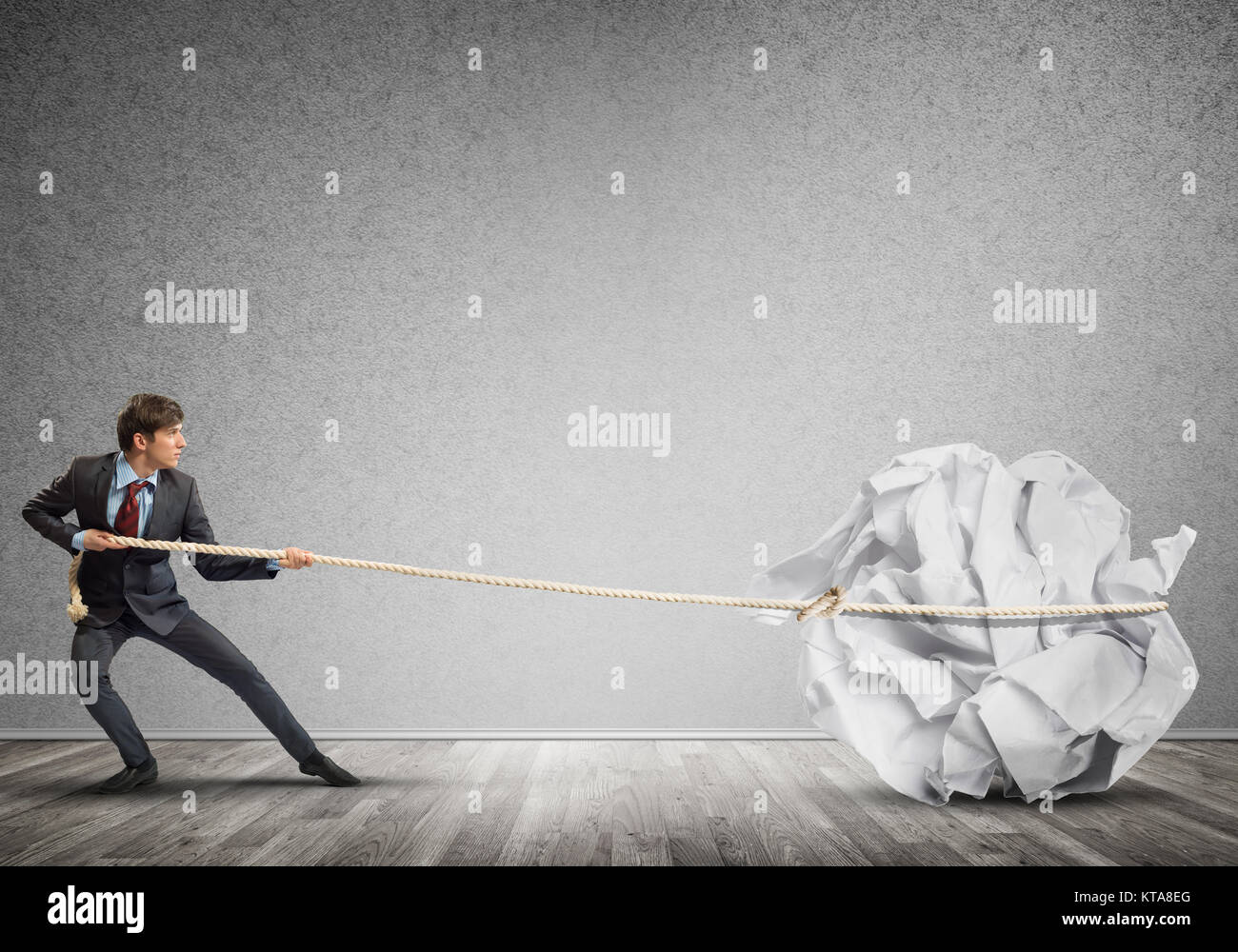 Young man making huge paper ball move Stock Photo - Alamy