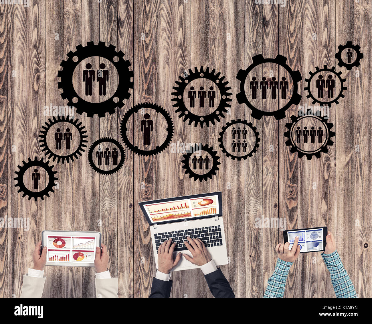 Group of three people with devices in hands working together as symbol ...