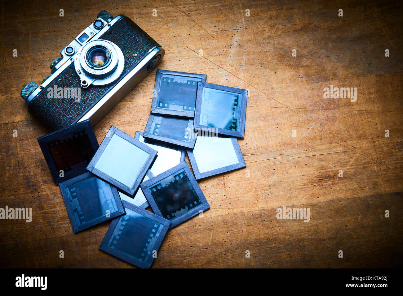 Vintage photo film camera with group of slides on a scratched old ...