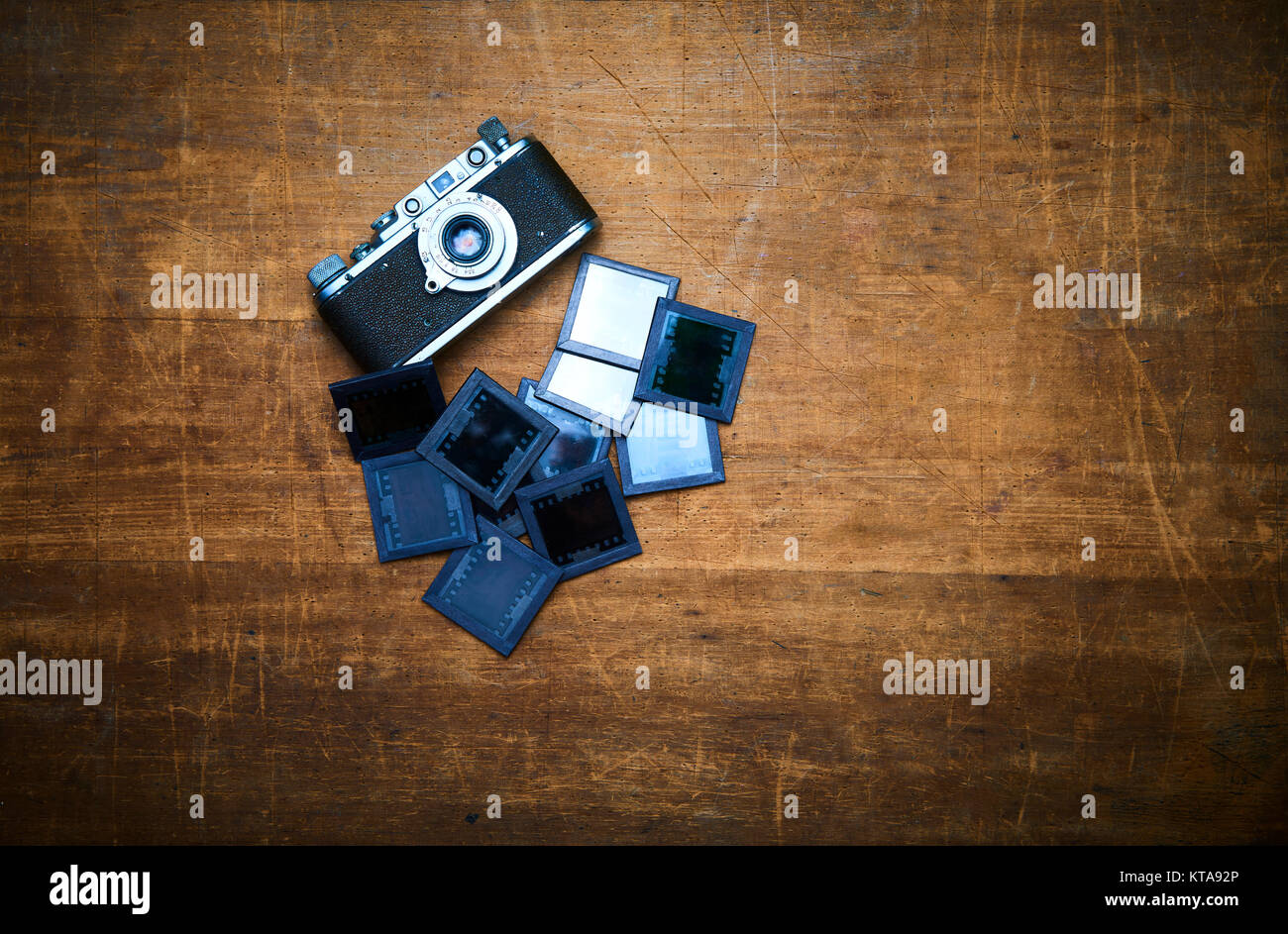 Vintage photo film camera with group of slides on a scratched old ...