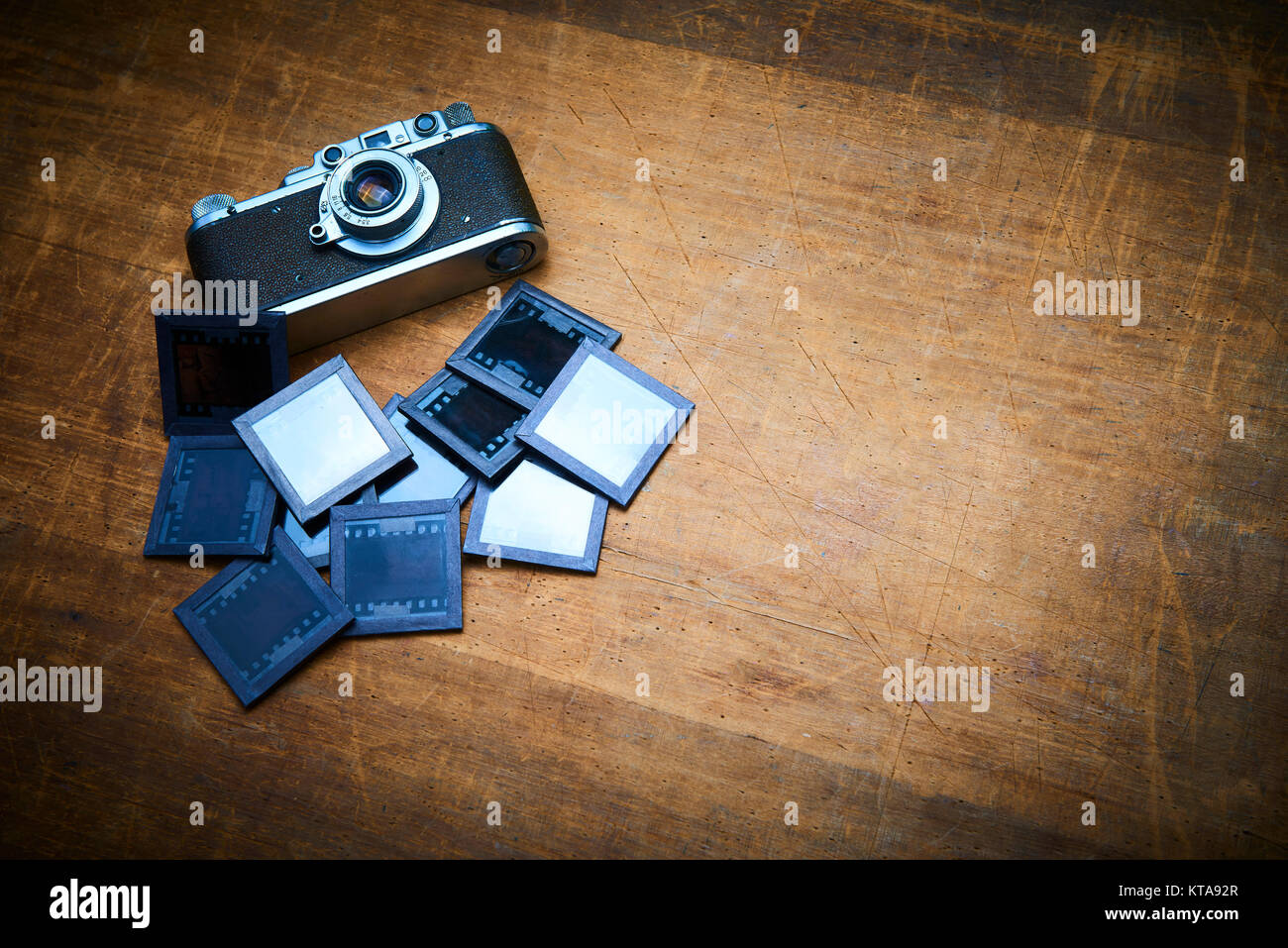 Vintage photo film camera with group of slides on a scratched old ...