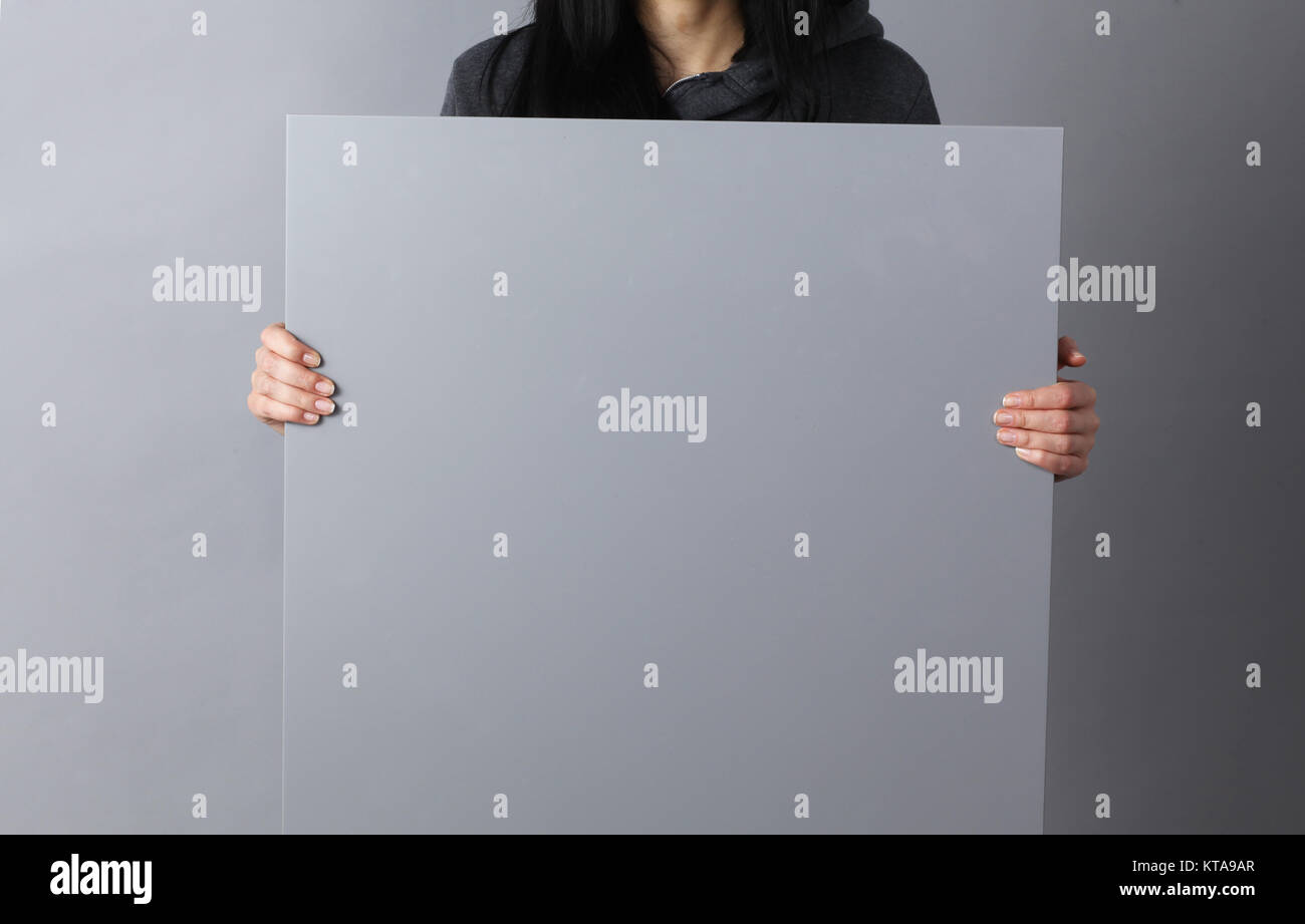 Happy young woman showing and displaying placard ready for your text or ...