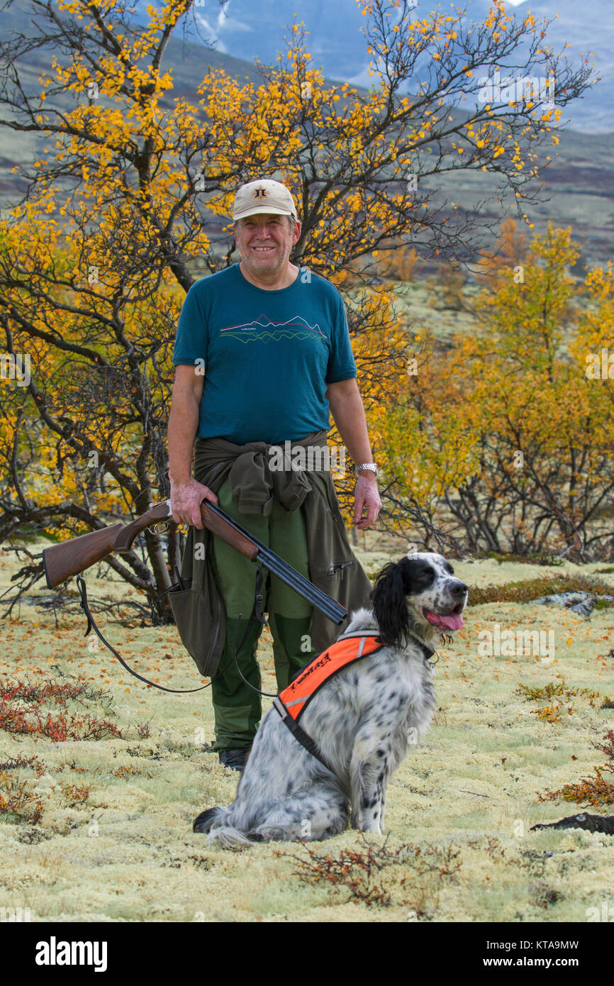 Norwegian hunter with shotgun and English Setter dog hunting grouse on ...
