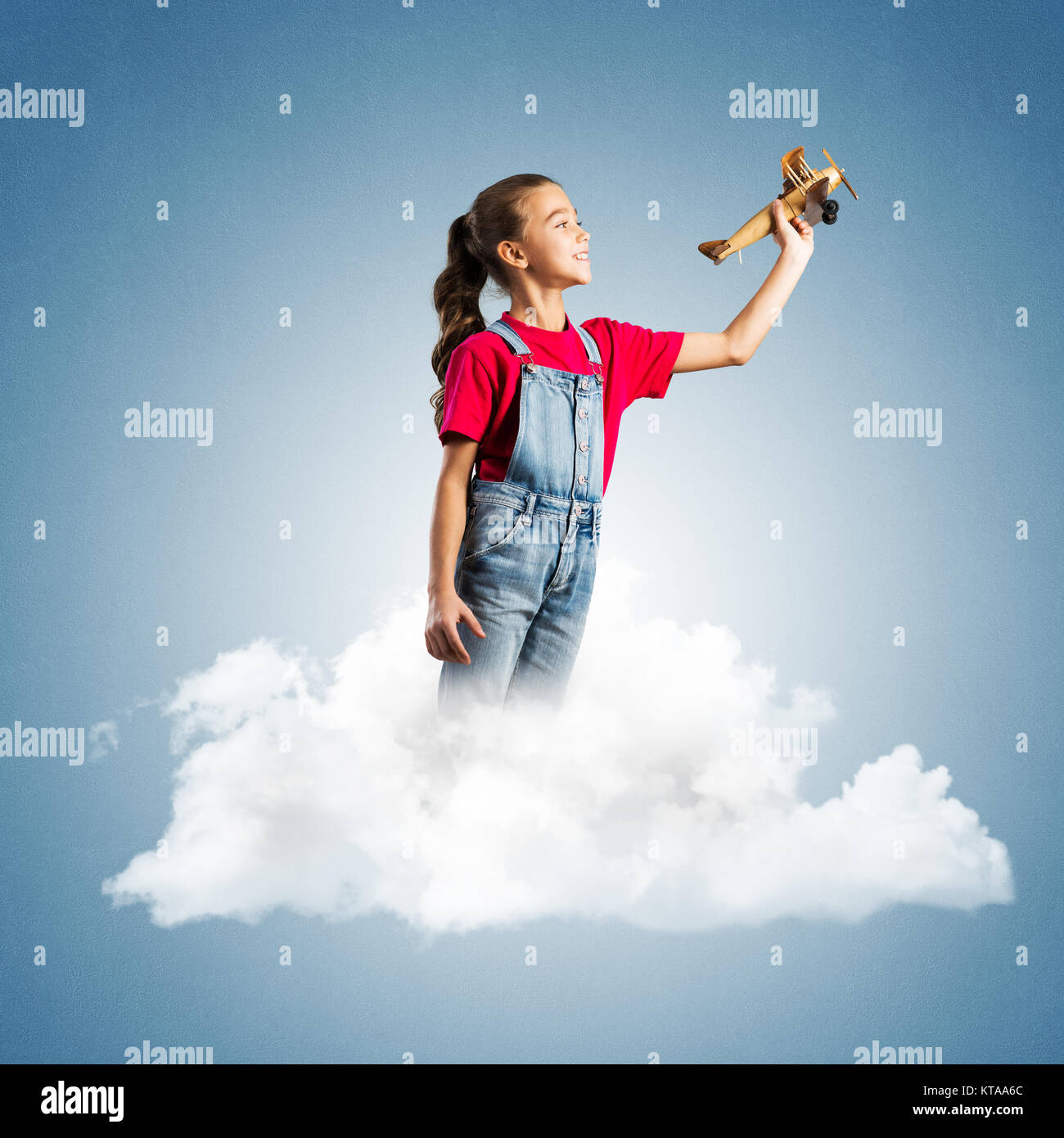 Cute kid girl standing on cloud and playing with airplane toy Stock ...