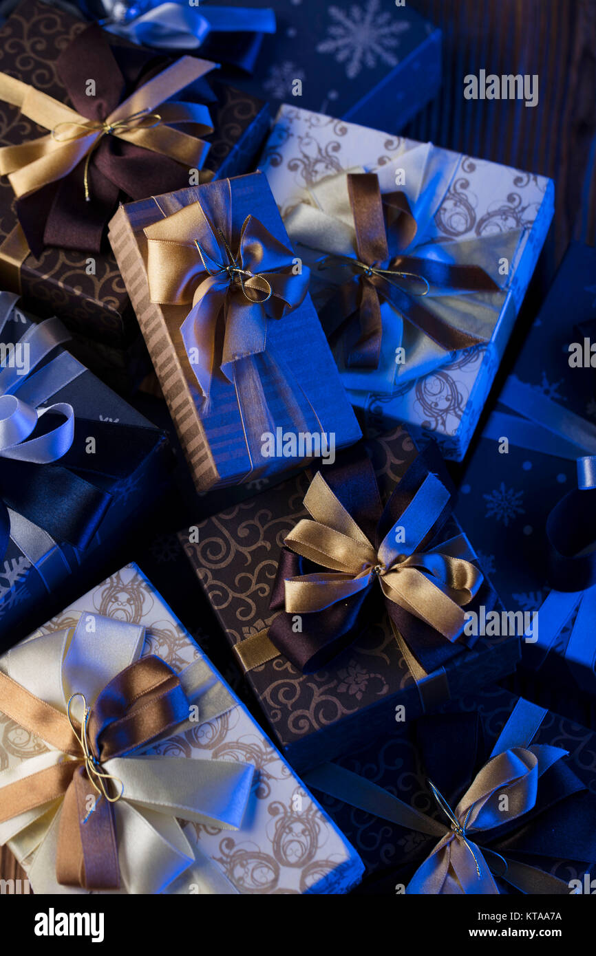 Presents in blue and gold aesthetics, rustic wooden table. Place for ...