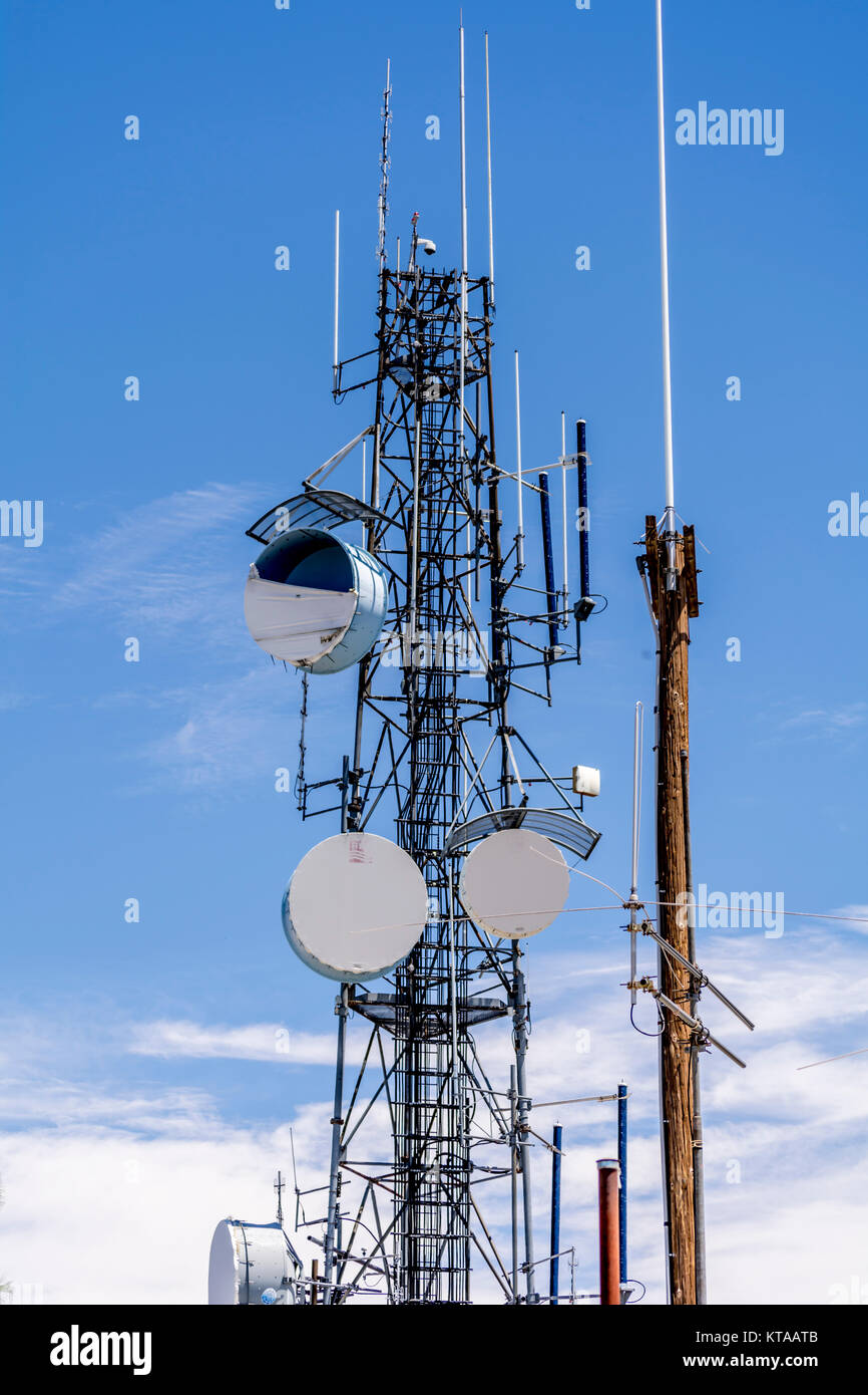 Radio communications tower with antennas and microwave dishes Stock Photo - Alamy