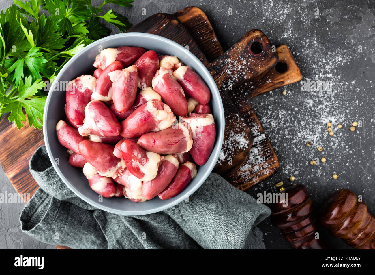 Fresh raw chicken hearts on dark background Stock Photo - Alamy