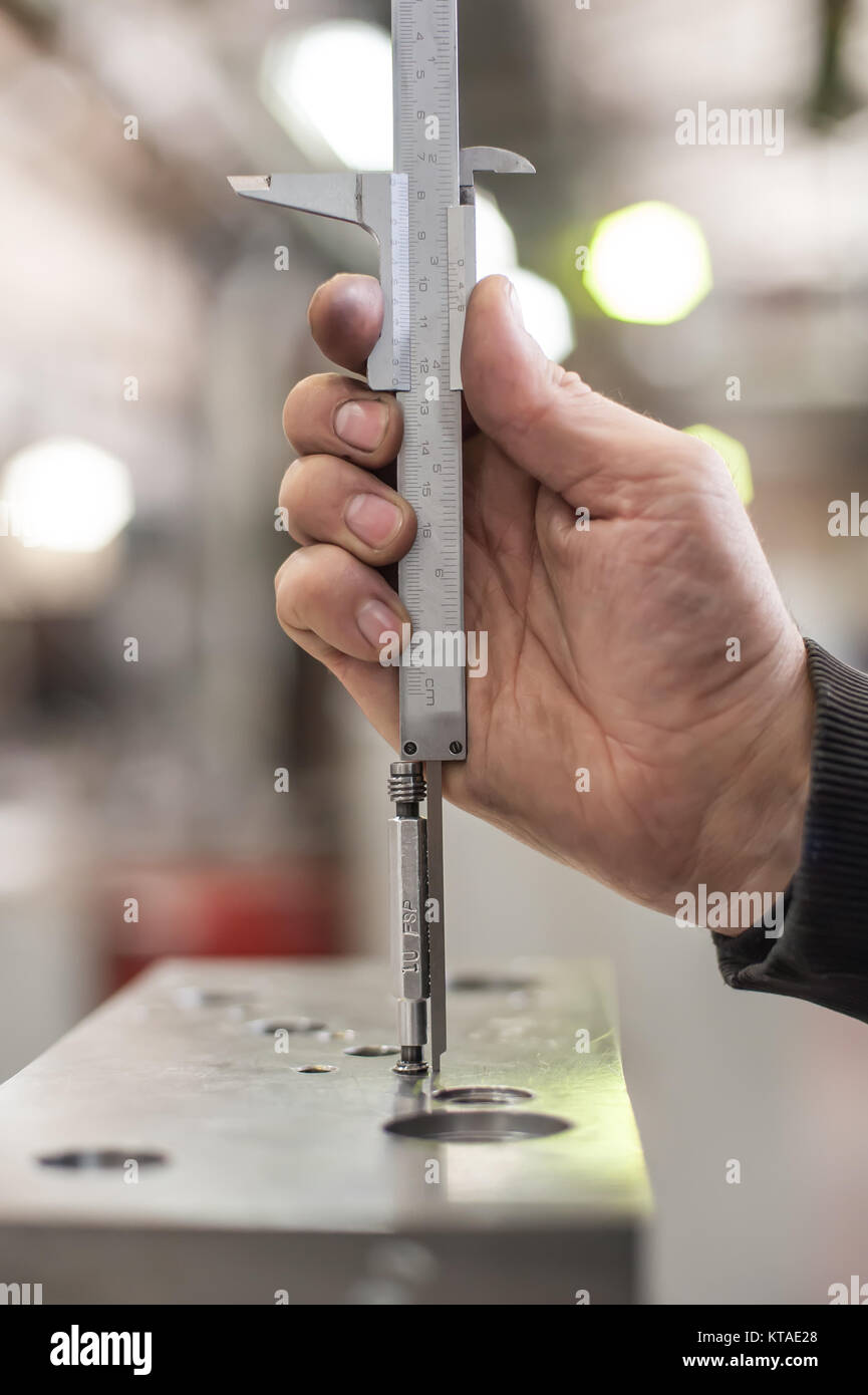 Repairer using accurate ruler for measuring in workshop. Close up Stock ...