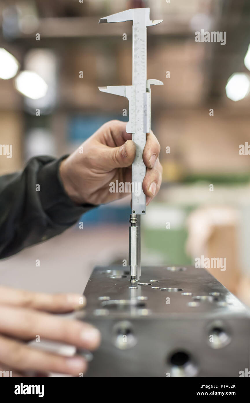 Repairer using accurate ruler for measuring in workshop. Close up Stock ...