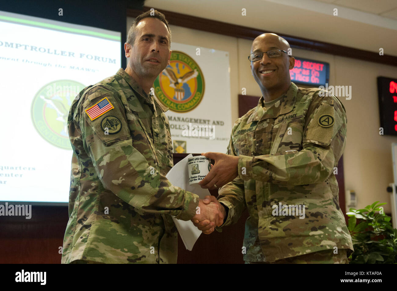 Colonel Brian Smith receives a token of appreciation from Brig. Gen ...