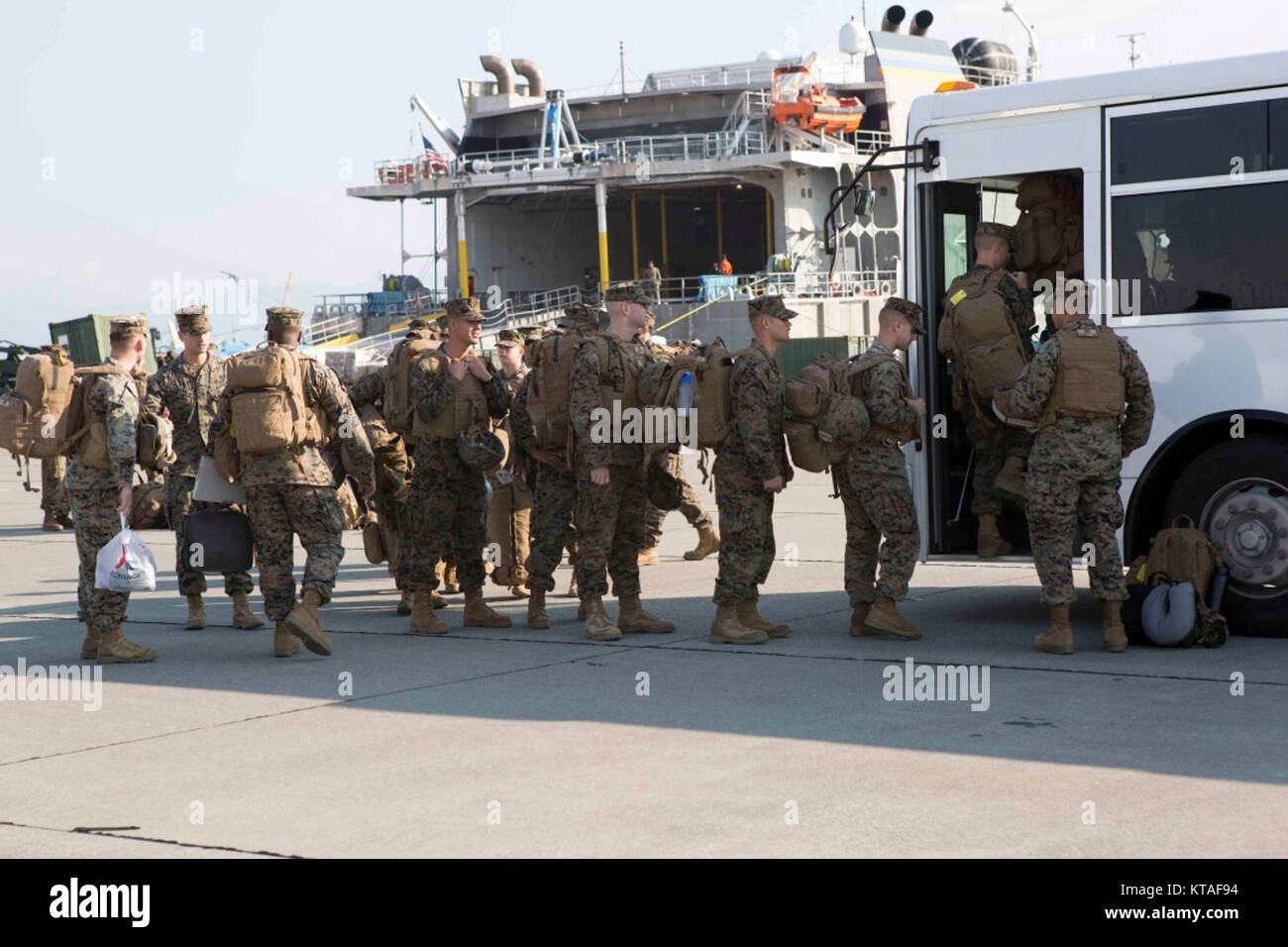 U.S. Marines with 2nd Battalion, 1st Marine Regiment, load onto a bus ...