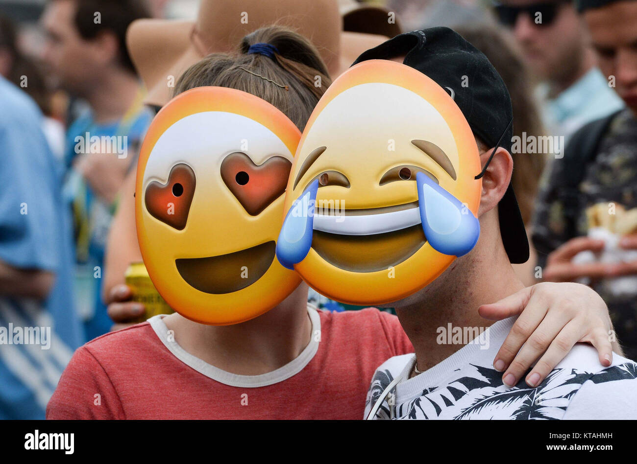 Review of the Year 2017: June: People wear emoji masks in the crowd in ...