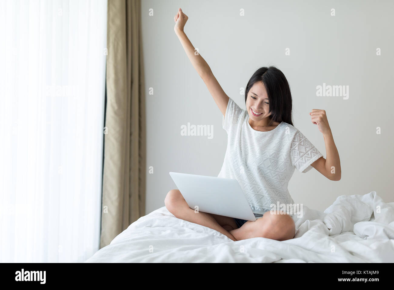 Happy woman working on laptop computer Stock Photo - Alamy