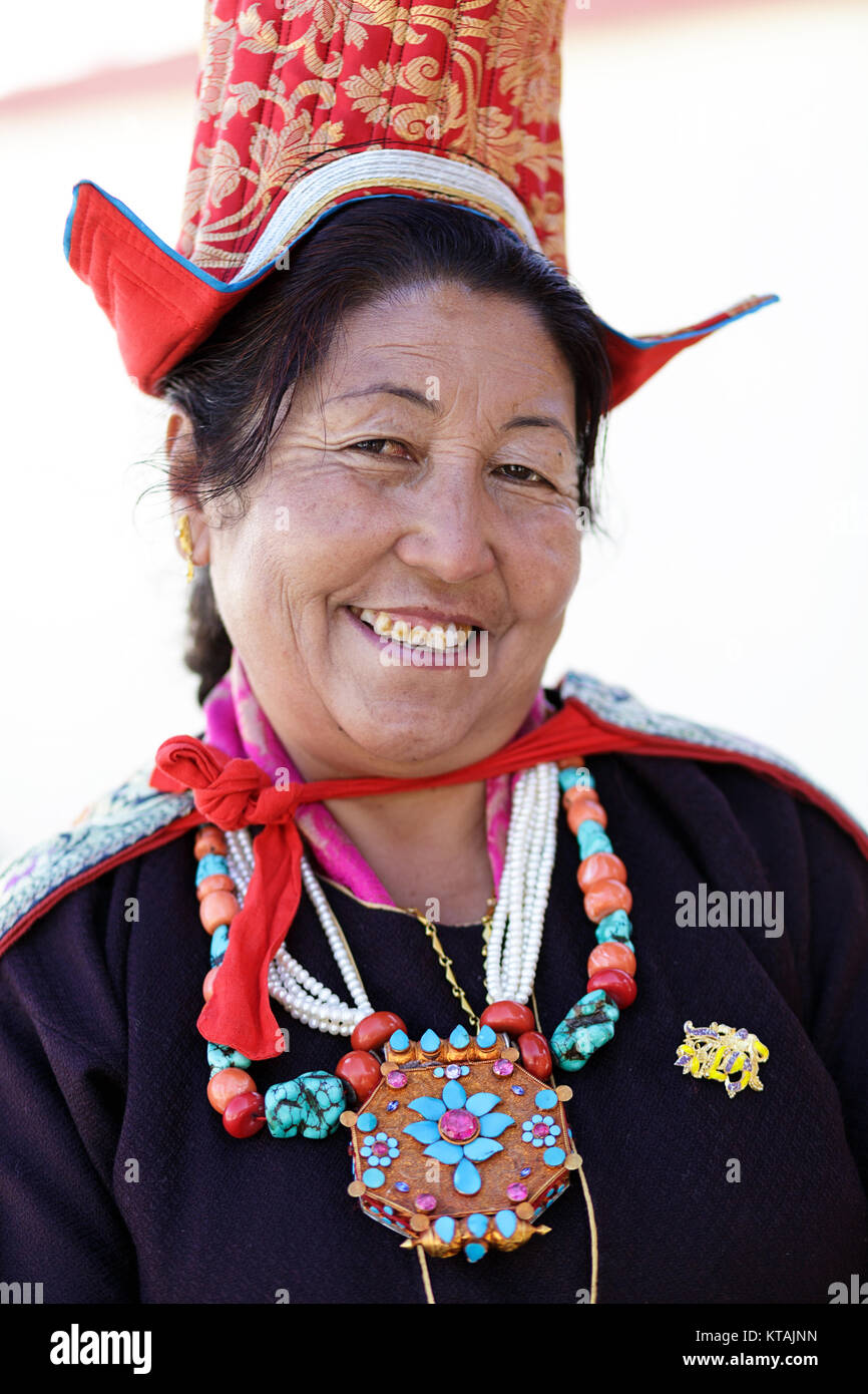Portrait of smiling lady in traditional costume and headwear at annual ...