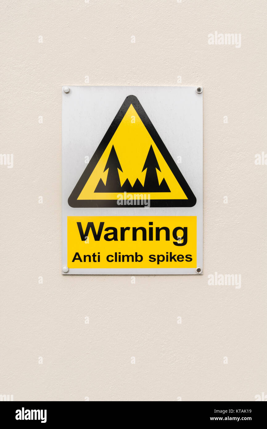 Anti-climb spikes warning sign - with copy space Stock Photo - Alamy