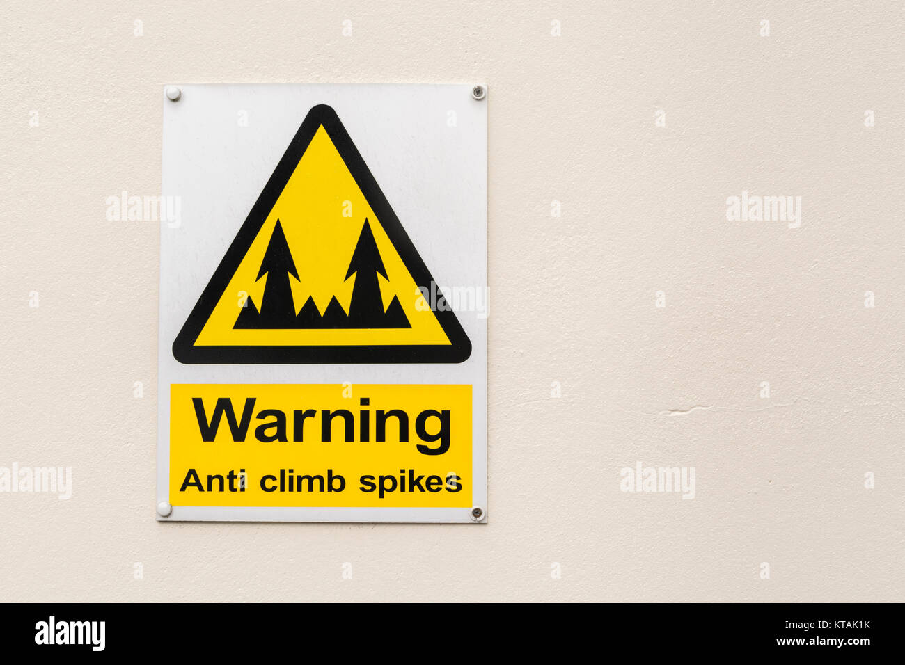 Anti-climb spikes warning sign - with copy space Stock Photo - Alamy
