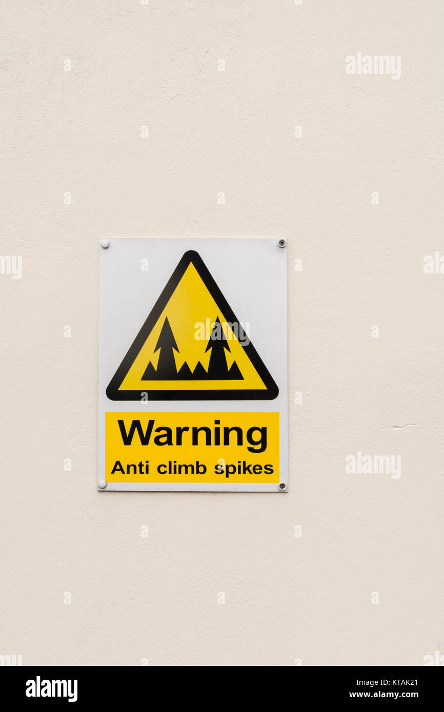 Anti-climb spikes warning sign - with copy space Stock Photo - Alamy