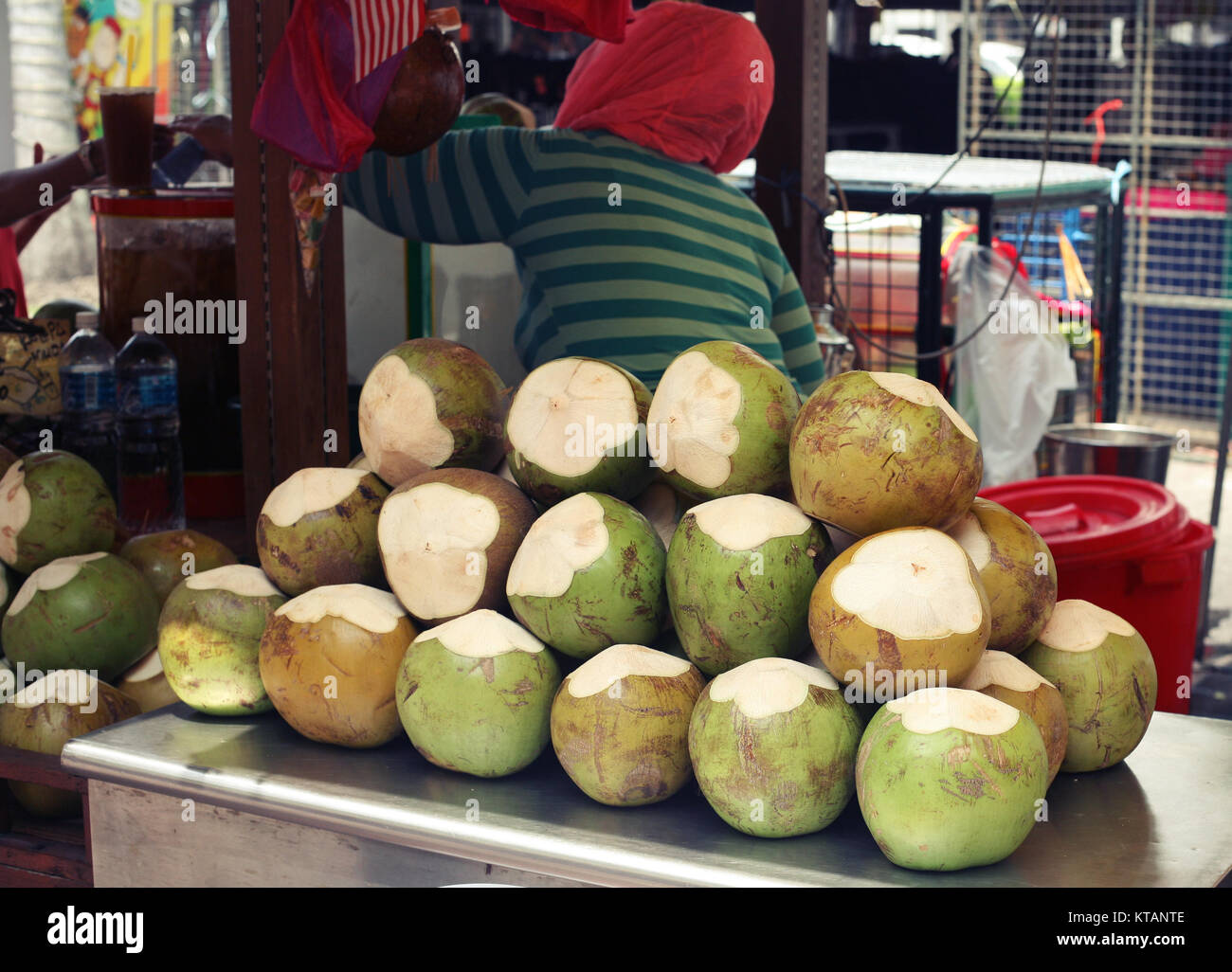 Woman sells coconut outdoor in Malaysia Stock Photo - Alamy