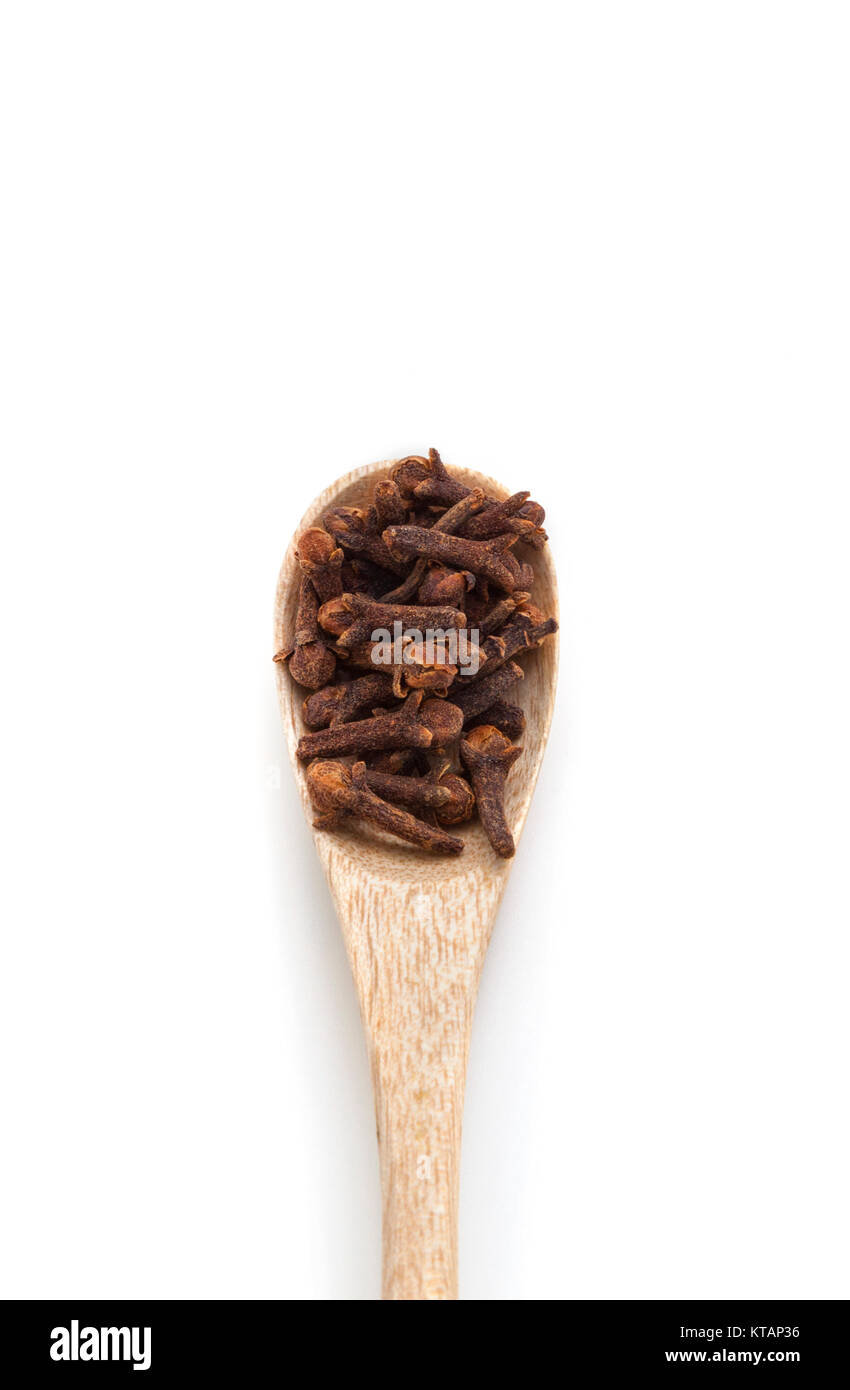 Cloves spices in wooden spoon isolated on white background Stock Photo ...