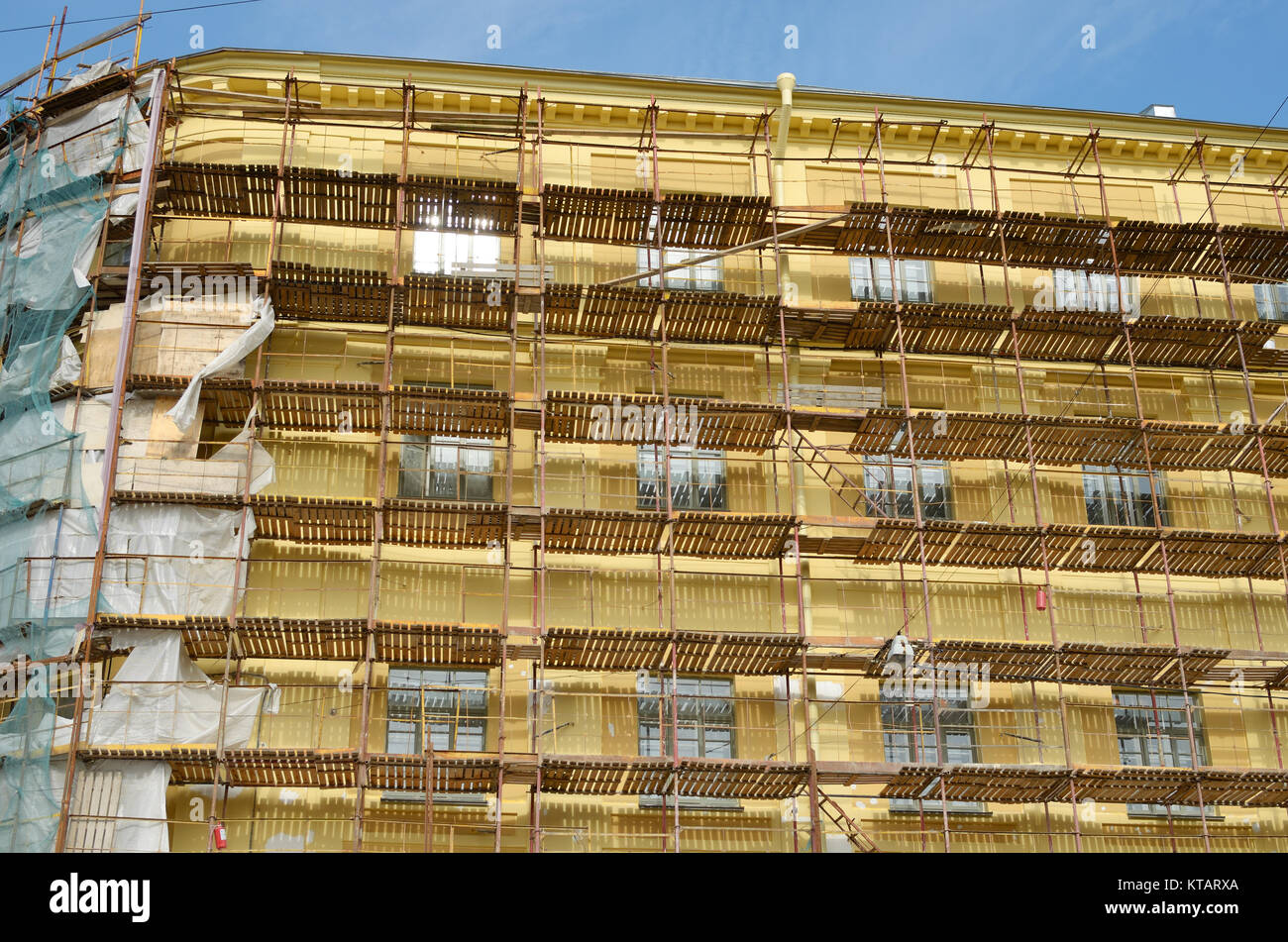 Construction scaffolding on the facade of the house.The restoration of ...