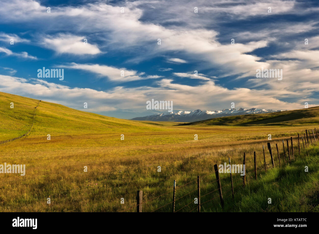 Evening clouds pass over the Zumwalt Prairie and the snow capped ...