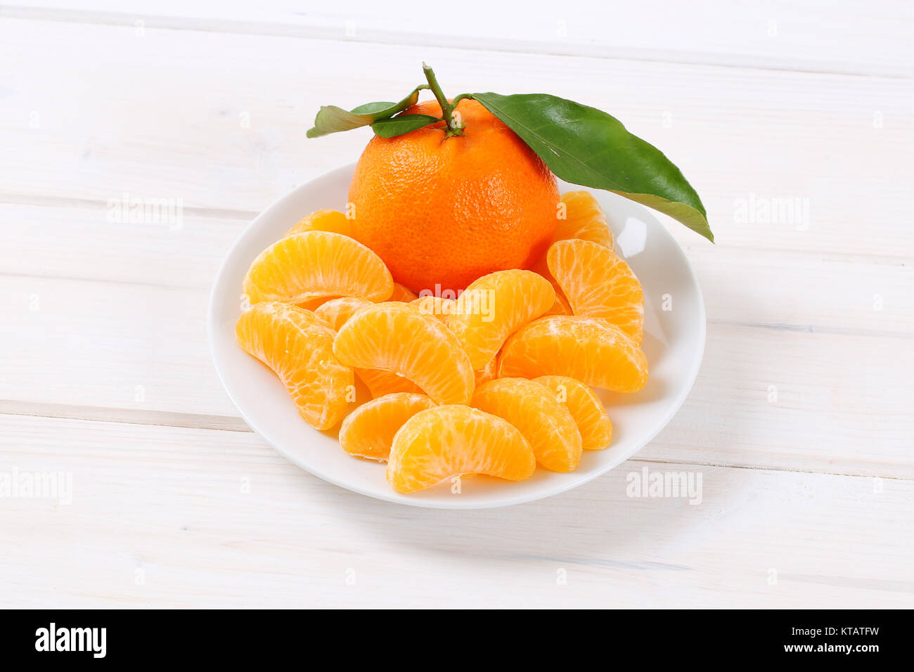 whole and peeled tangerines Stock Photo - Alamy