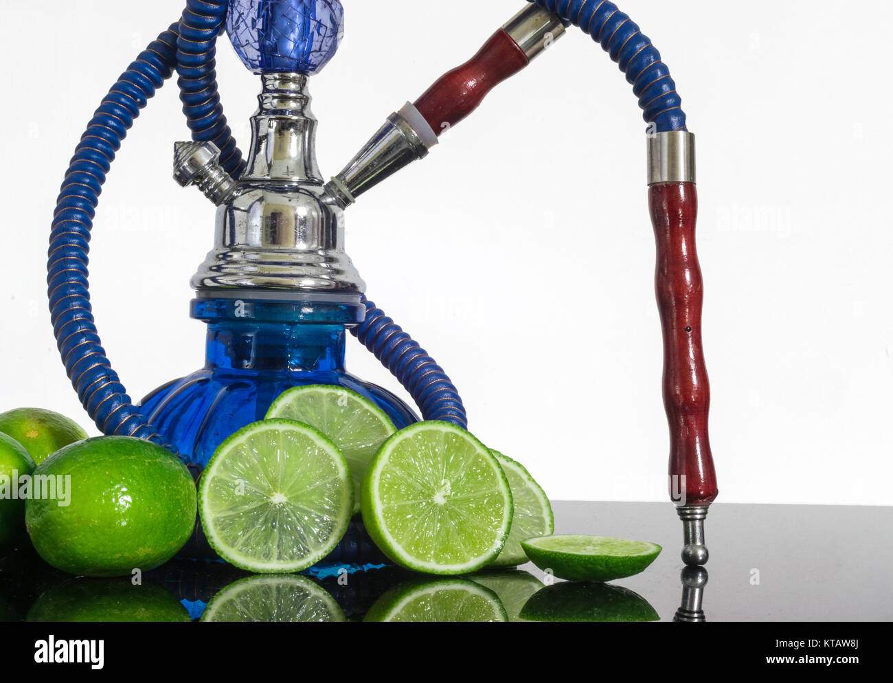 Hookah on top of a reflective surface, with lemons and lime, white ...