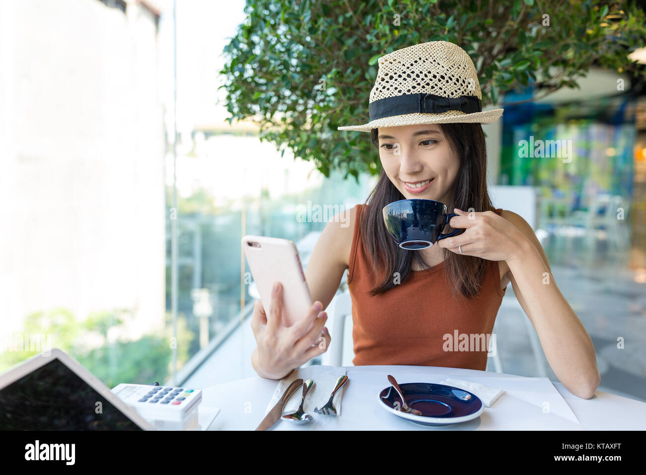 Woman use of mobile phone in coffee shop Stock Photo - Alamy