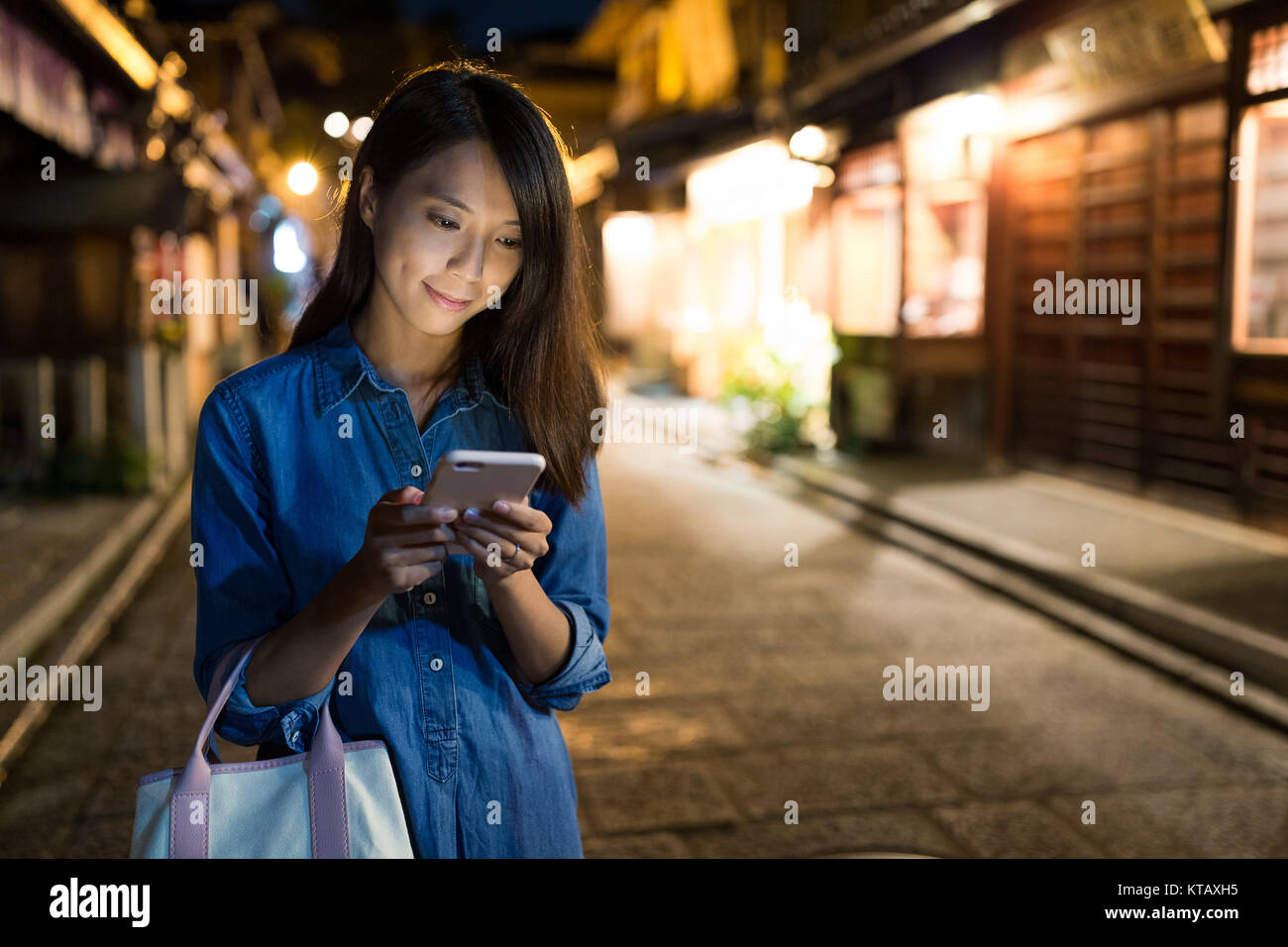 Woman use of mobile phone at night Stock Photo - Alamy