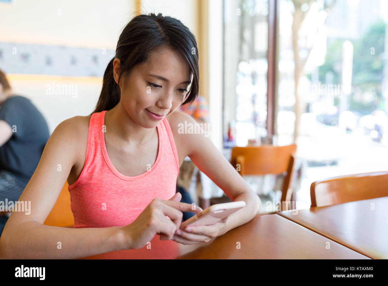 Woman use of mobile phone in coffee shop Stock Photo - Alamy