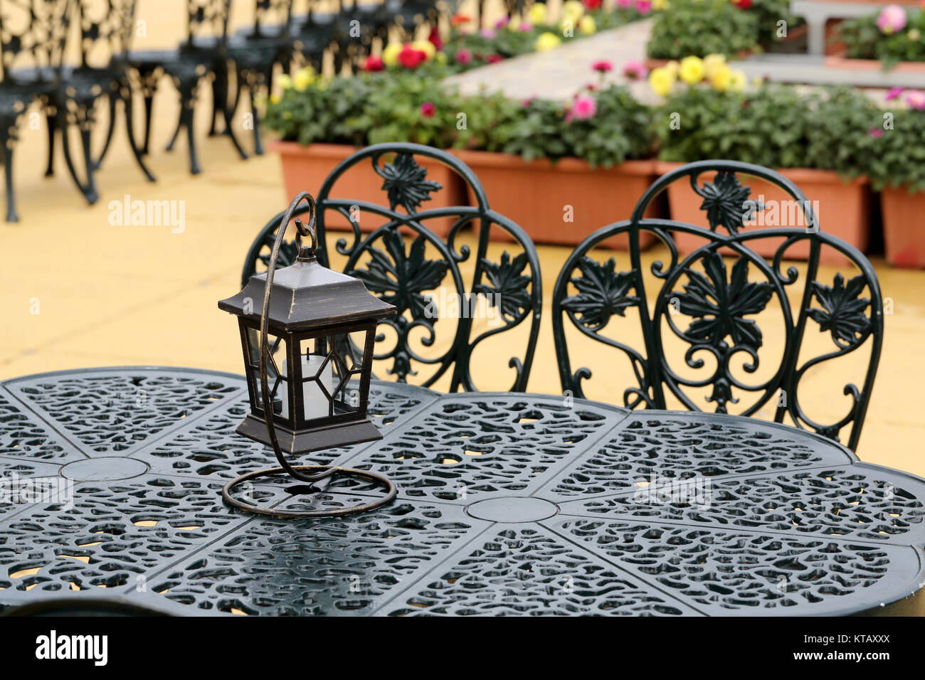 chairs and tables with old lantern, outdoor cafe Stock Photo - Alamy