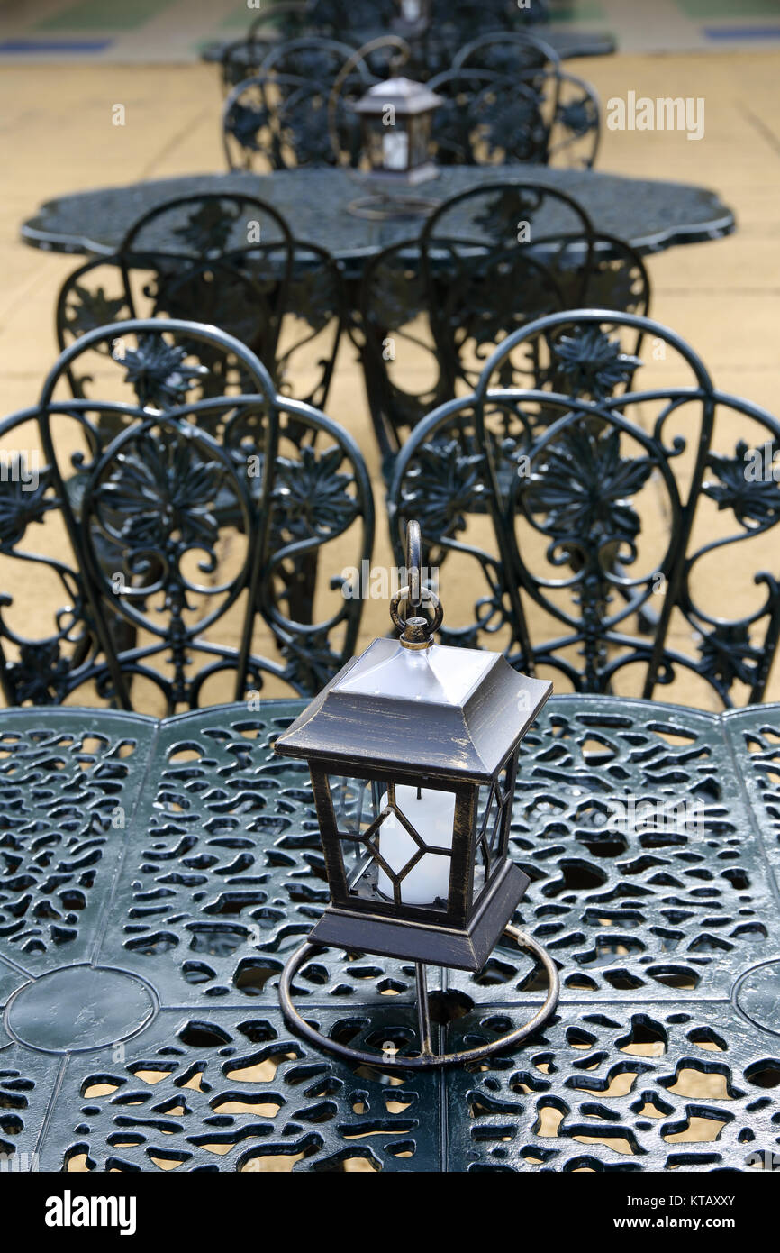 vintage lantern with chairs and table, outdoor restaurant Stock Photo ...