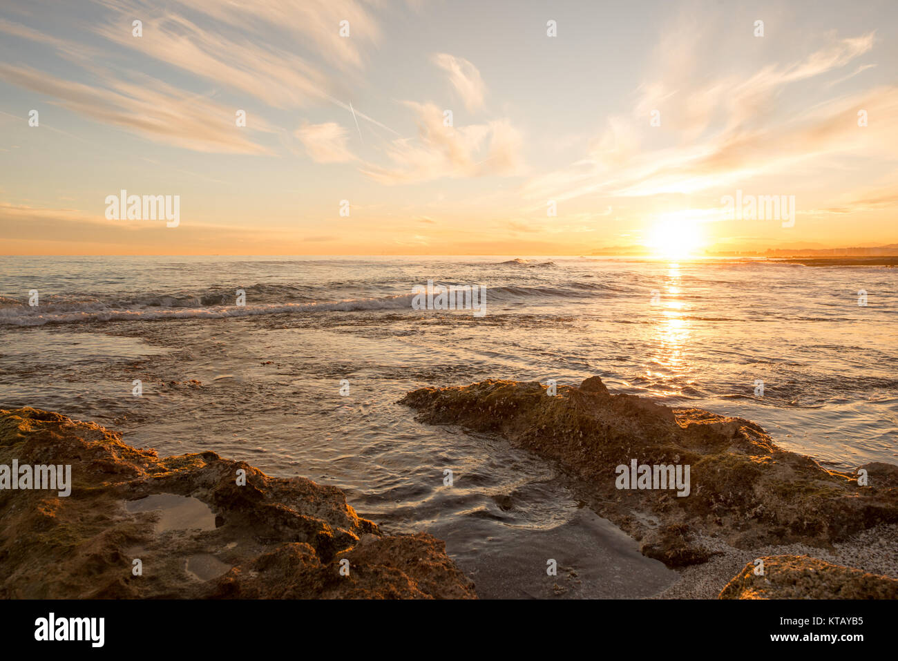 The calm sea in a very cloudy sunset in Spain Stock Photo - Alamy