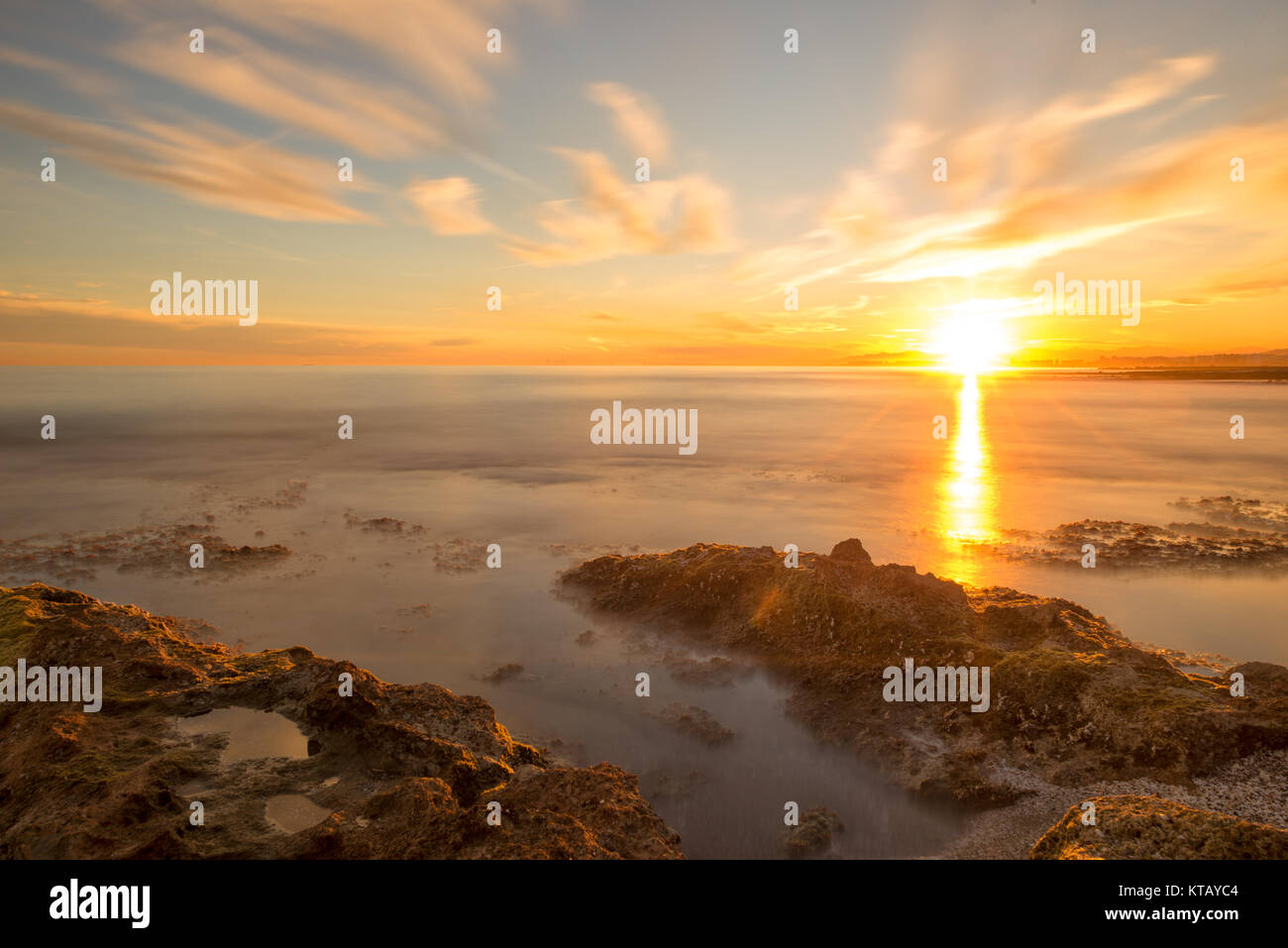 The calm sea in a very cloudy sunset in Spain Stock Photo - Alamy