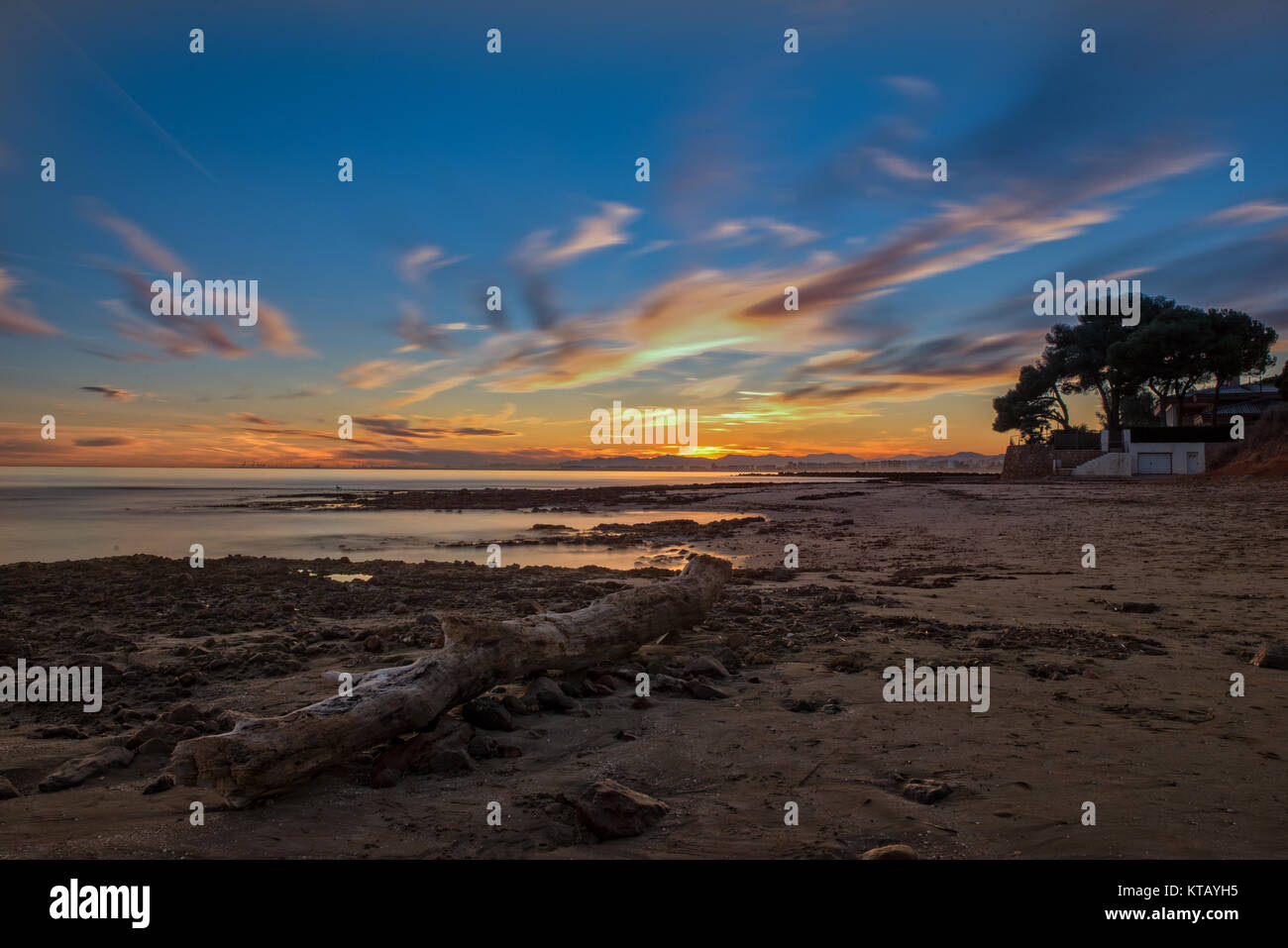 The calm sea in a very cloudy sunset in Spain Stock Photo - Alamy