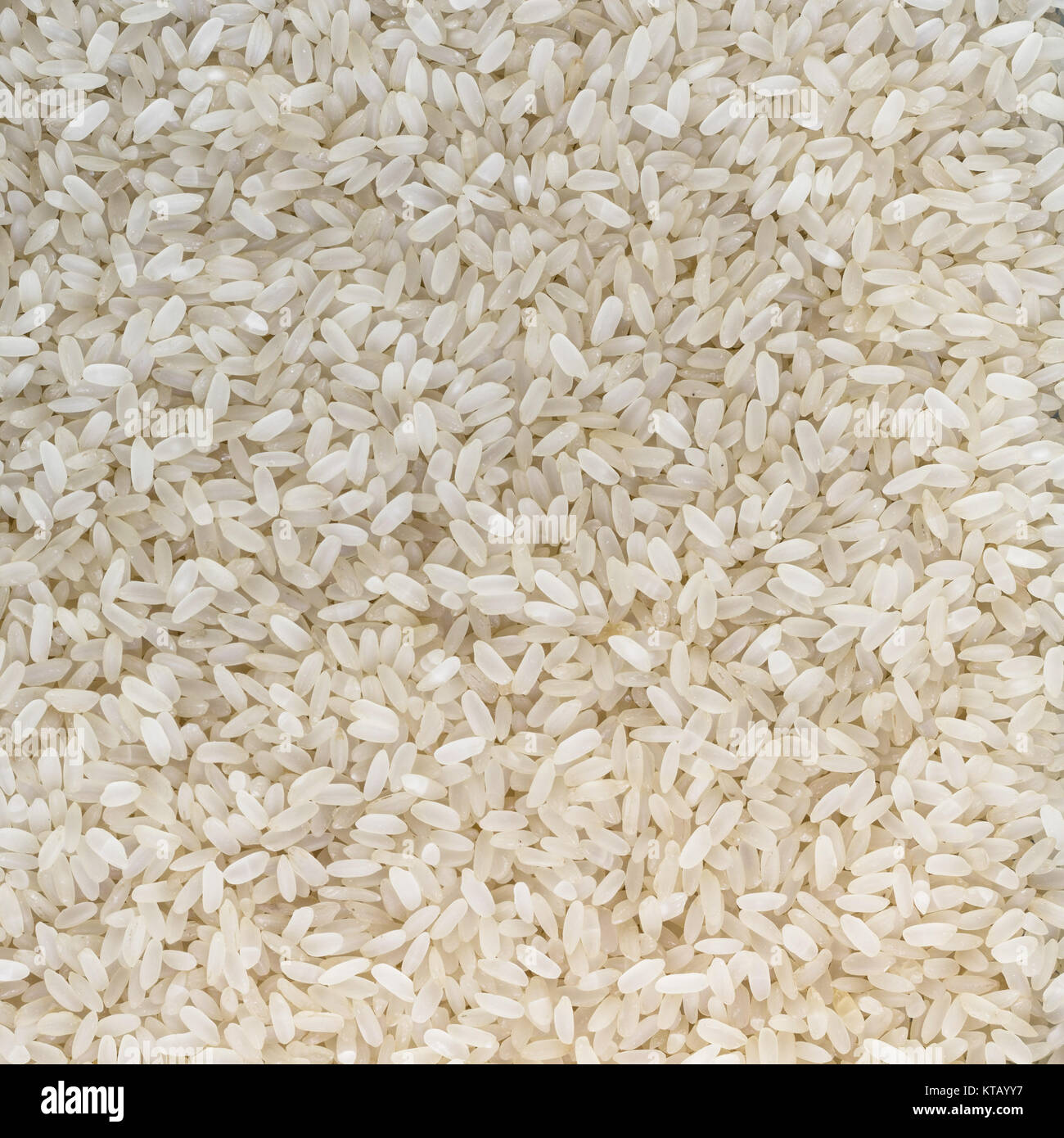 Uncooked white rice background Stock Photo - Alamy