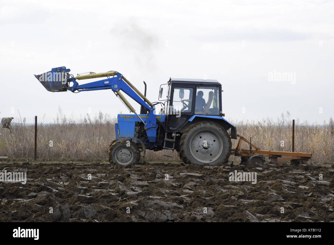 Tractor plowing the garden. Plowing the soil in the garden Stock Photo ...