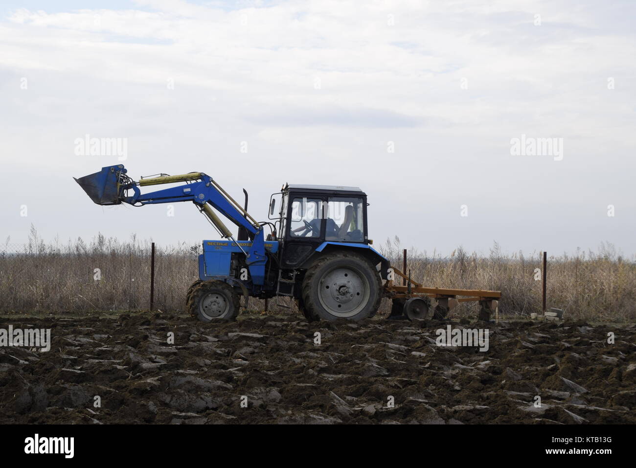 Tractor plowing the garden. Plowing the soil in the garden Stock Photo ...