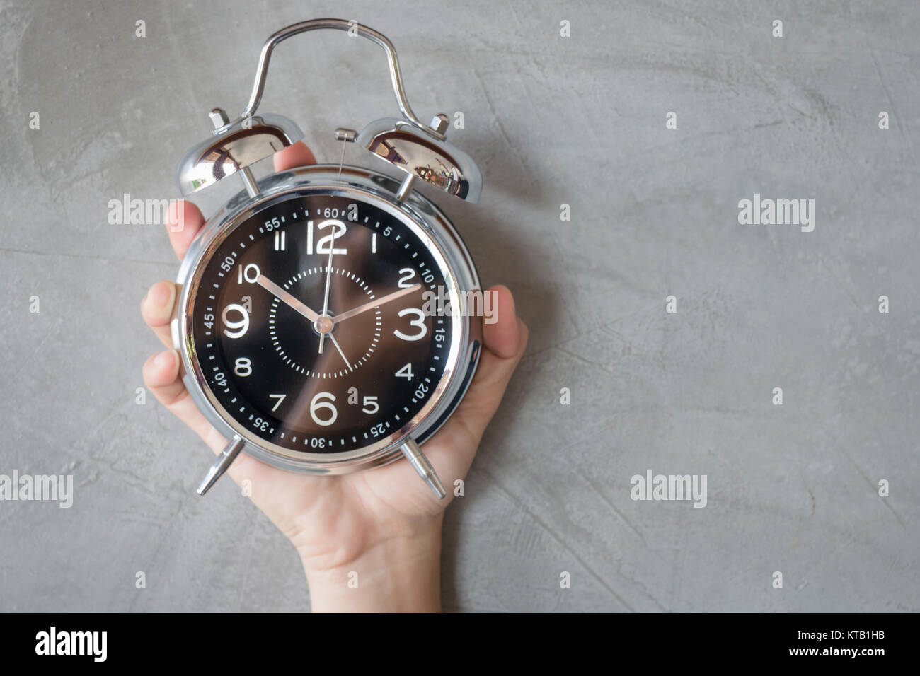 Woman Hand On Alarm Clock Stock Photo - Alamy