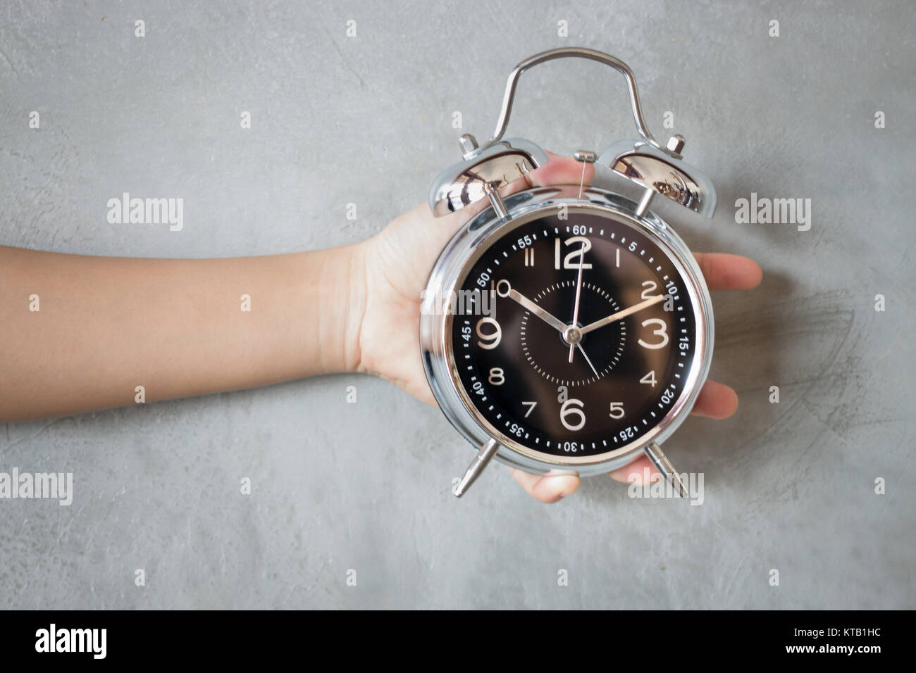 Woman Hand On Alarm Clock Stock Photo - Alamy