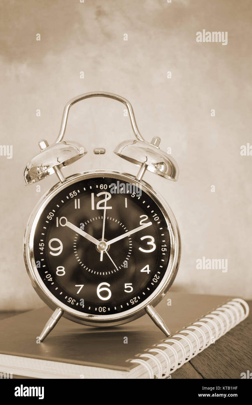 Alarm Clock On Wooden Work Table Stock Photo - Alamy