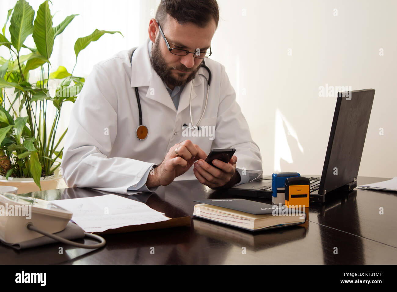 the physician selects the number on the phone Stock Photo - Alamy